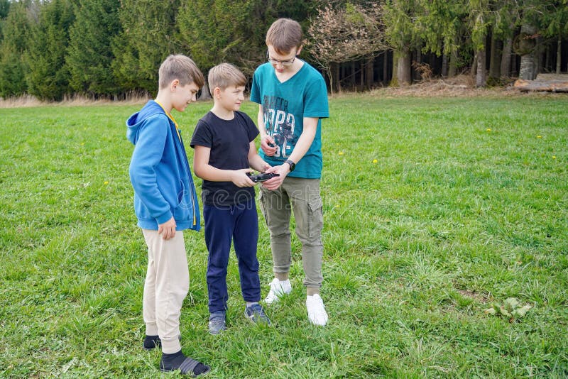 Children Together Launch the Quadcopter and Control it from the Remote ...