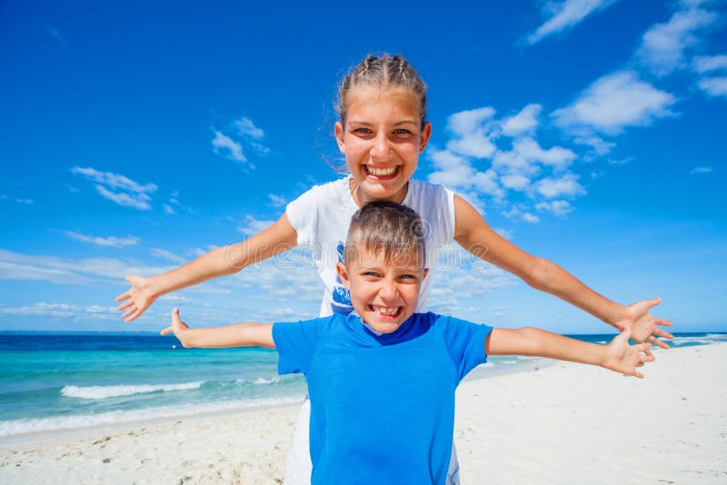Children at tropical beach stock image. Image of sibling - 69564985