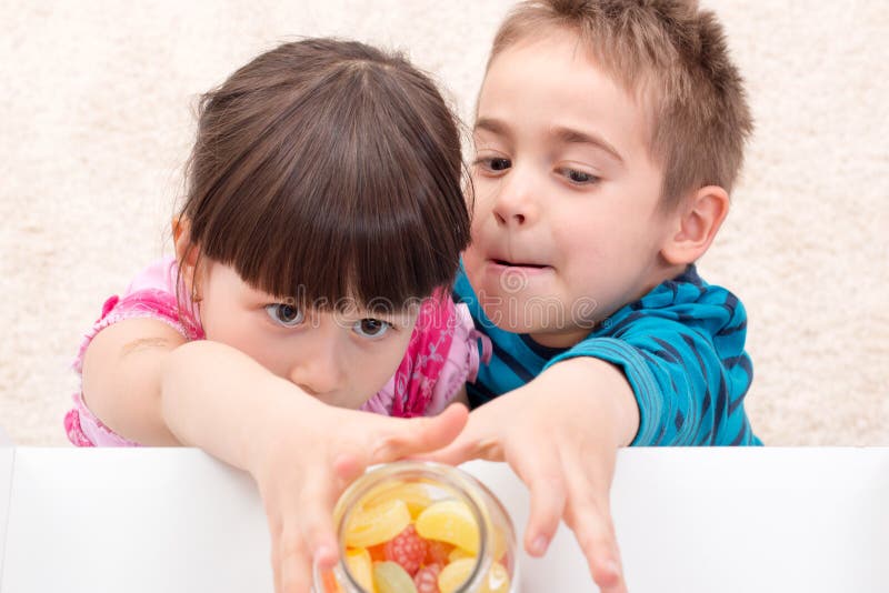 Children taking candy stock photo. Image of young, candy - 109069984