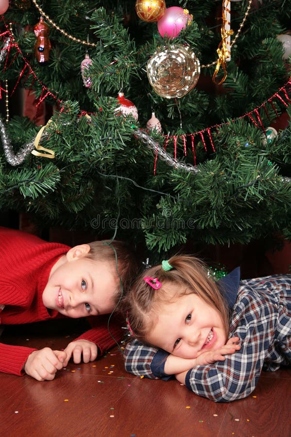 Children Under Christmas Tree Stock Image - Image of pretty, love: 4485031