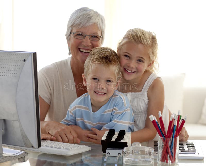 Children Using a Computer with Their Grandmother Stock Photo - Image of ...