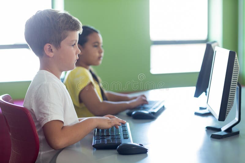 Children using computers stock image. Image of elementary - 77703755