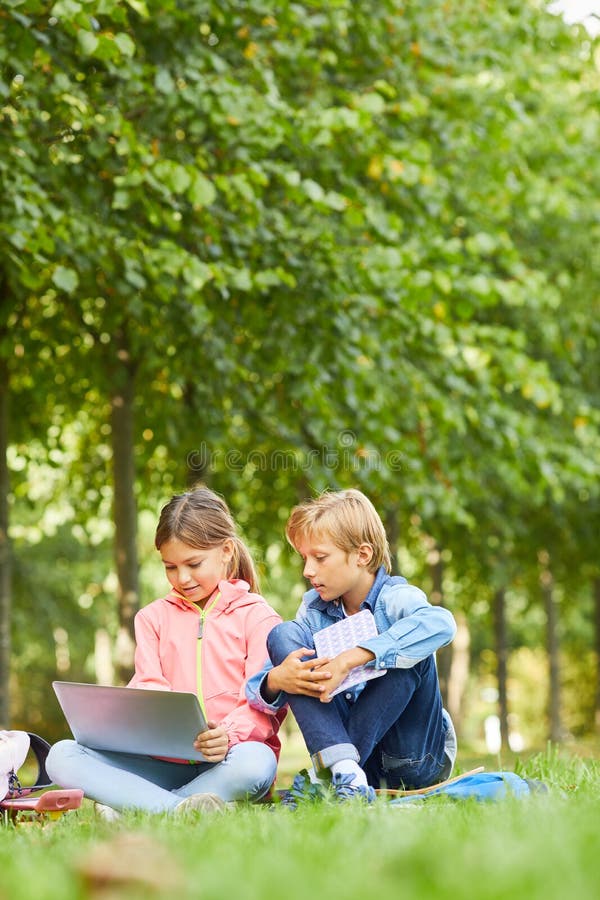 Children Using Laptop for Study Stock Photo - Image of males, grass ...