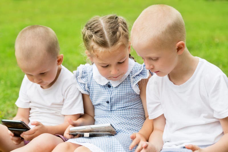 Children Using Smartphones in Park Stock Image - Image of happiness ...