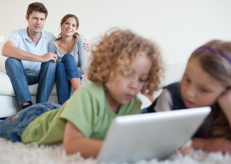 Children Using a Tablet Computer with Parents Stock Image - Image of ...