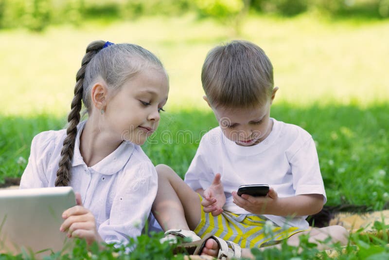 Children Using Tablet PC and Smartphone in Perk Stock Image - Image of ...