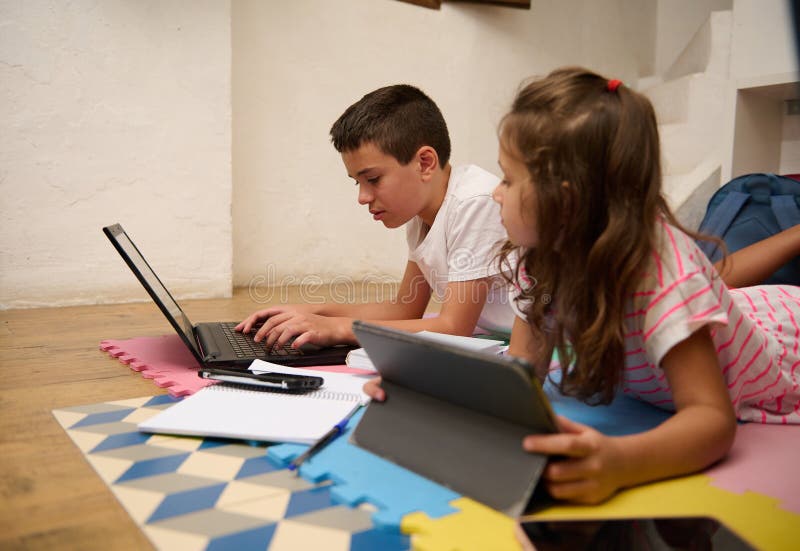 Children Using Technology for Learning at Home on Floor Mats Stock ...
