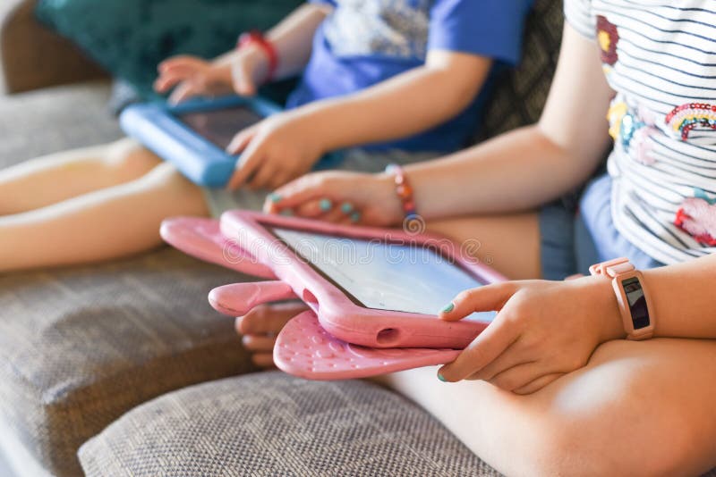 Children Using Their Tablet Device To Play Computer Games and Use ...