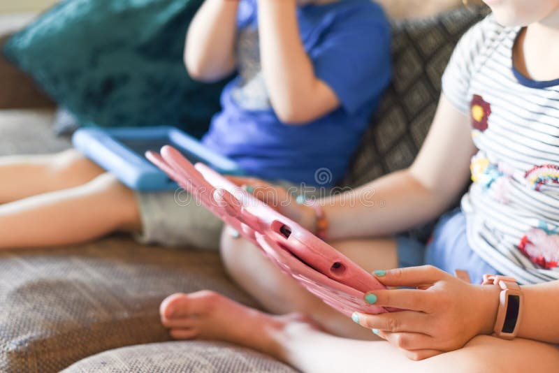 Children Using Their Tablet Device To Play Computer Games and Use ...