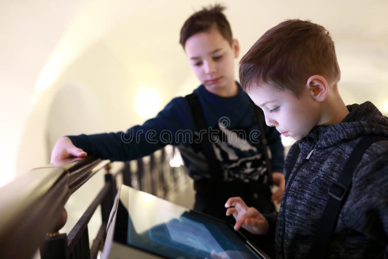 Children Using Touch Screen in Entertainment Center Stock Photo - Image ...