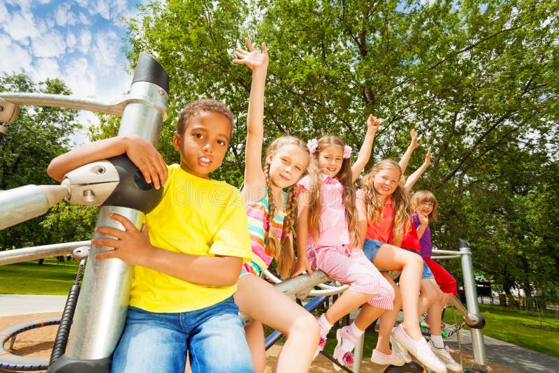 Children Waiving Hands Sitting on Round Bar Stock Photo - Image of ...
