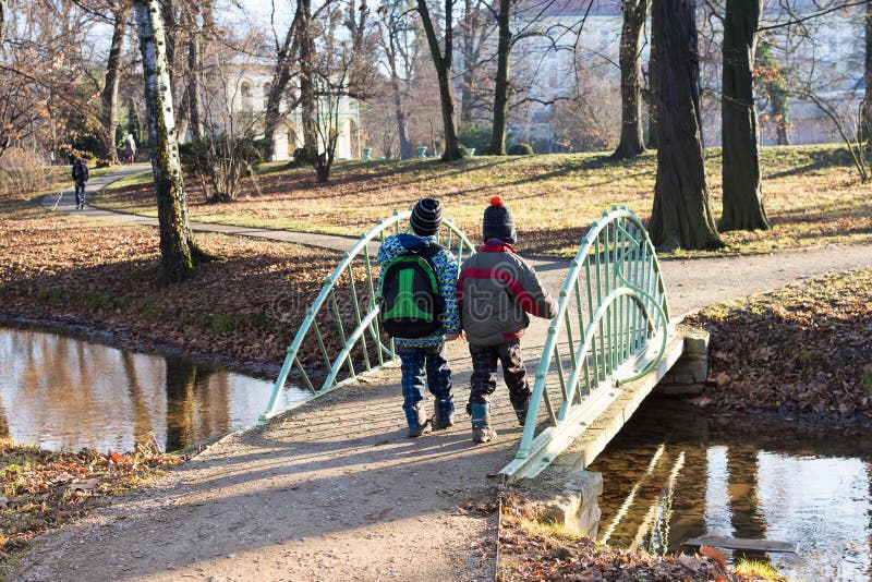 Children Walking Over Bridge in Park Stock Image - Image of outdoor ...