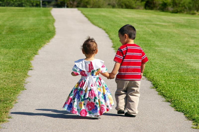Children Walking Together on a Sidewalk Stock Photo - Image of help ...
