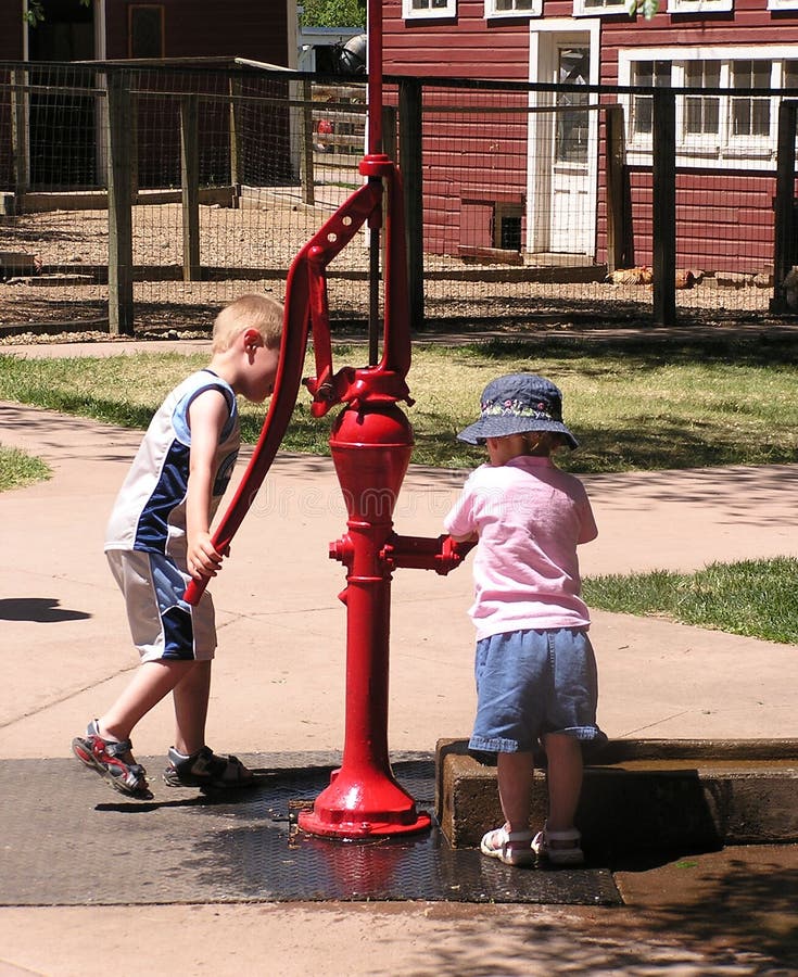 Children at Water Pump stock photo. Image of cistern, brothers - 135170