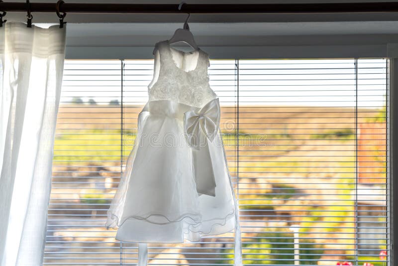 Children Wedding Dress Hanging on Window Cornices Stock Photo - Image ...