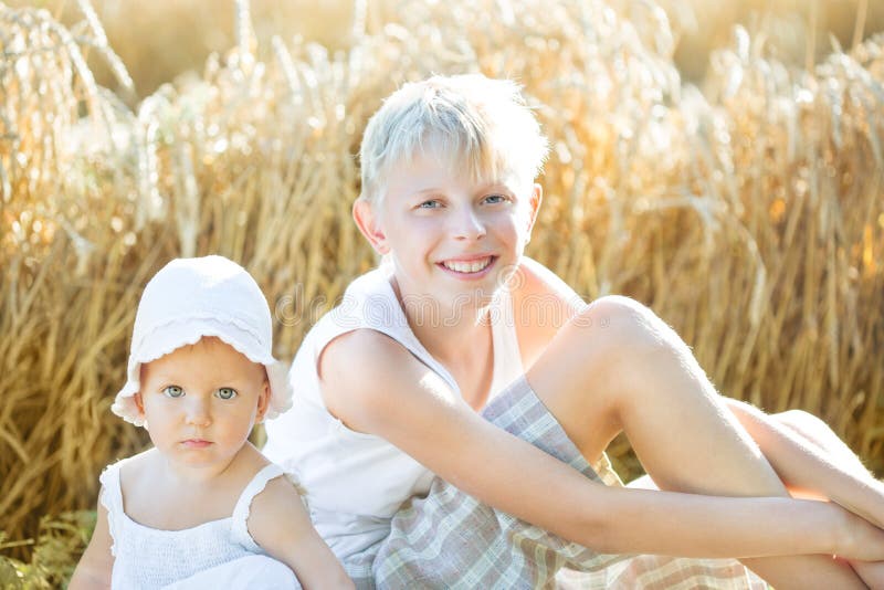 Children in a wheat field stock photo. Image of together - 56323010