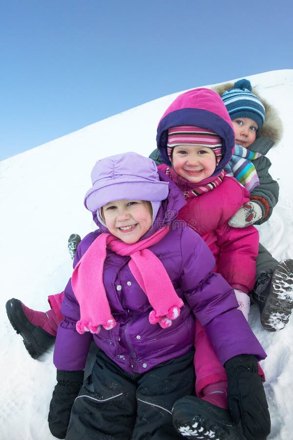 Three Children Playing in Snow Stock Photo - Image of contentment ...