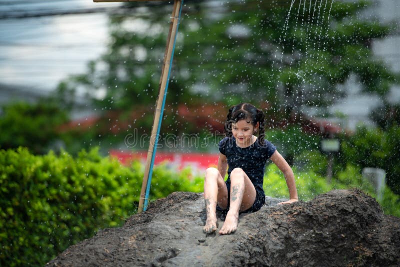 Childrens Have Fun Playing Mud Slides in the Community Fields Stock ...