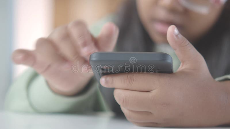 A Childs Hand Skillfully Using a Smartphone with a Focused and Engaging ...