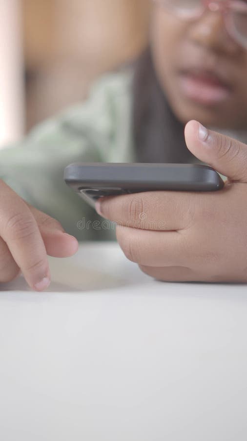 A Childs Hand Skillfully Using a Smartphone with a Focused and Engaging ...