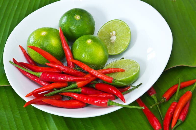 Limes and Chilli Peppers stock image. Image of vegetable - 3902305