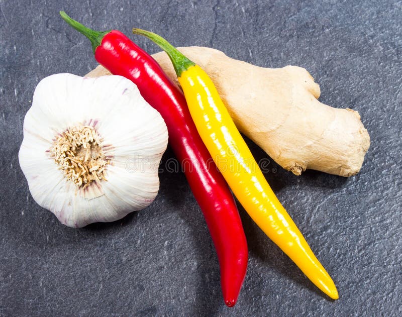 Chili Peppers, Garlic and Ginger on a Black Background Stock Photo ...