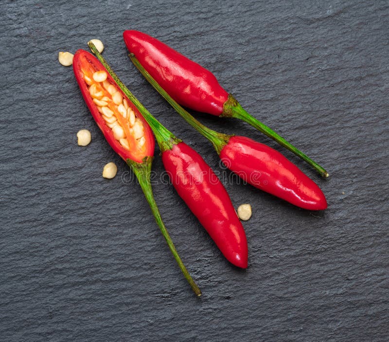 Chilli Pepper or Hot Red Peppers on Natural Stone Black Slate Plate ...