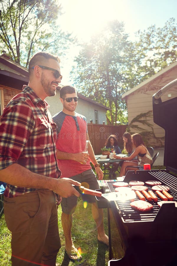 Chillin while Grillin. Friends Having a Barbecue Outside. Stock Image ...