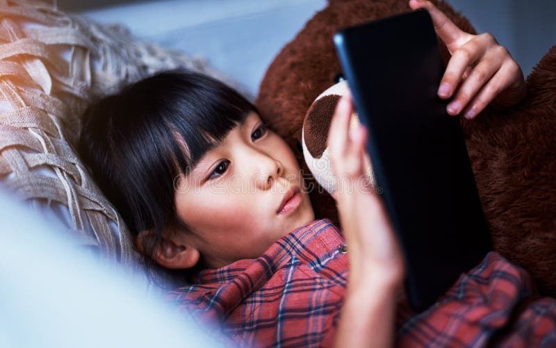 Chilling As a Modern Day Kid Would. a Little Girl Using a Digital ...