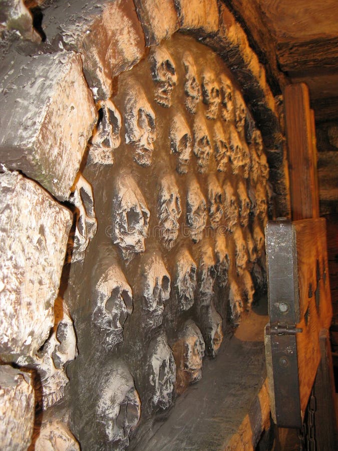 A Chilling Cave Wall Adorned with an Array of Preserved Human Skulls ...