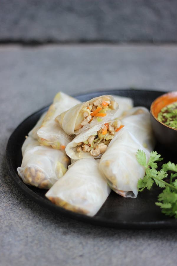 Chinese Chicken Spring Rolls Recipe with Herbs on Black Plate Stock ...