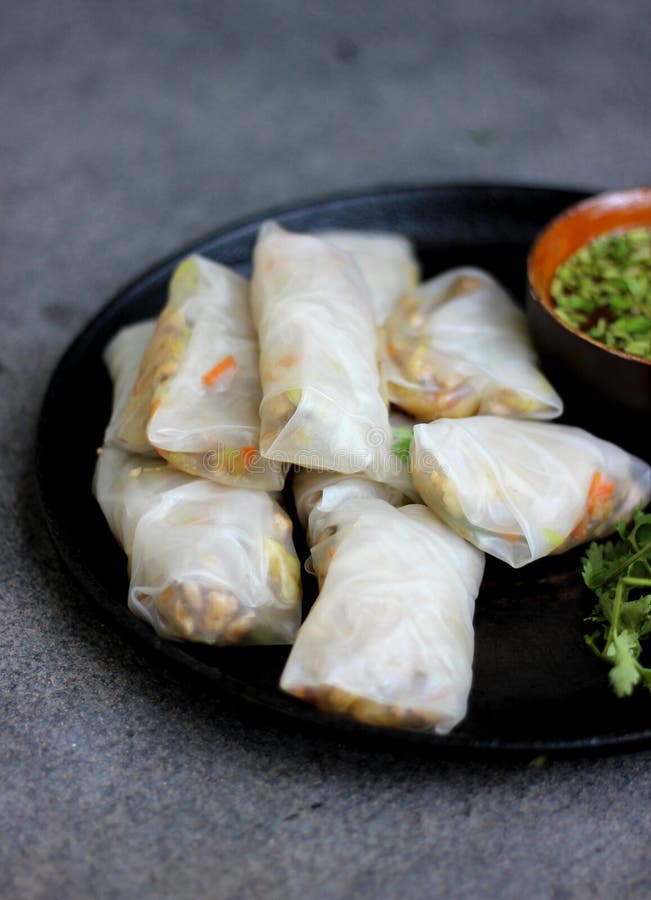 Chinese Chicken Spring Rolls Recipe with Herbs on Black Plate Stock ...