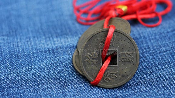 Chinese Coins with Red Thread on Jeans Stock Photo - Image of asian ...