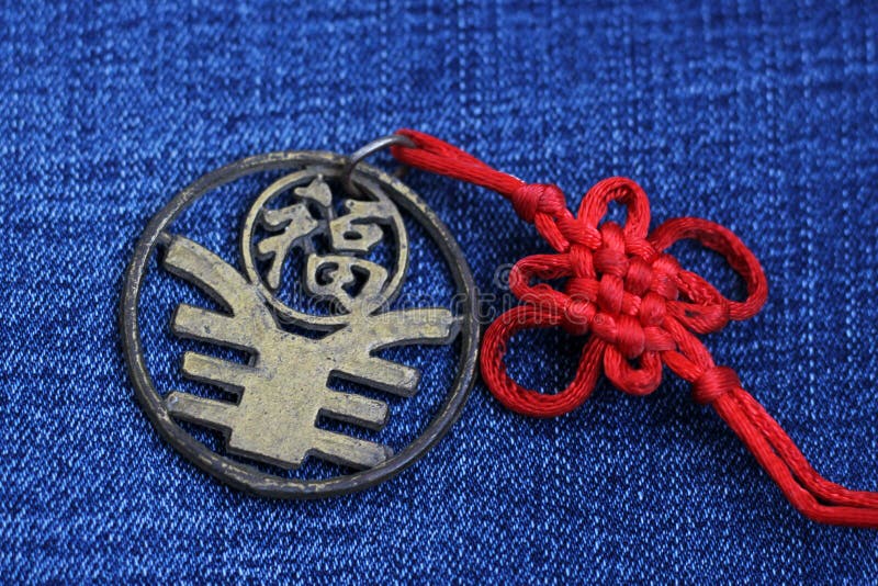 Chinese Coins with Red Thread on Jeans Stock Photo - Image of aged ...