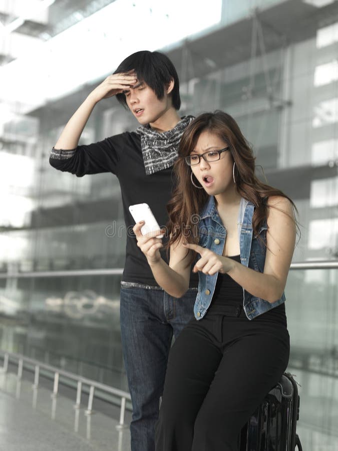 Chinese Couple Shocked Over Their Flight Plans Stock Image - Image of ...