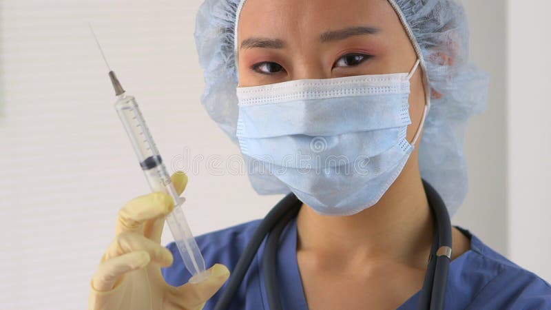 Chinese doctor with needle stock footage. Video of cute - 257836358