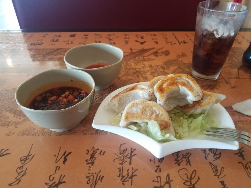 Chinese Dumplings and Spicy Sauce and Soda on Table Stock Photo - Image ...