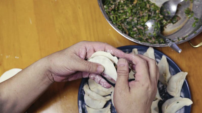 A Chinese Family Sitting Together Making Dumplings Stock Footage ...