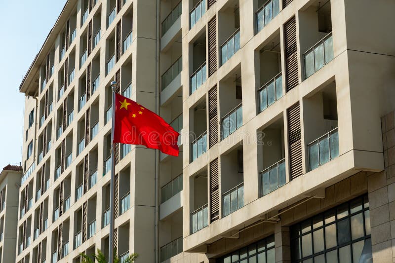 Chinese Flag on the Background of a Tall Building in the Center of the ...