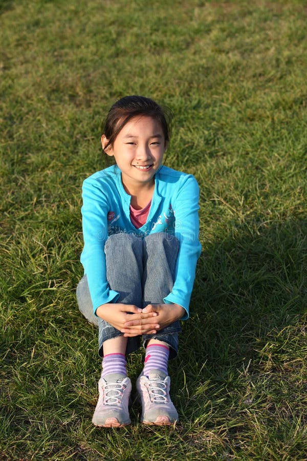 Chinese girl sitting lawn stock photo. Image of burden - 23571360