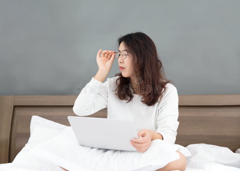 Chinese Lady Sitting on Bed and Using Computer Stock Photo - Image of ...