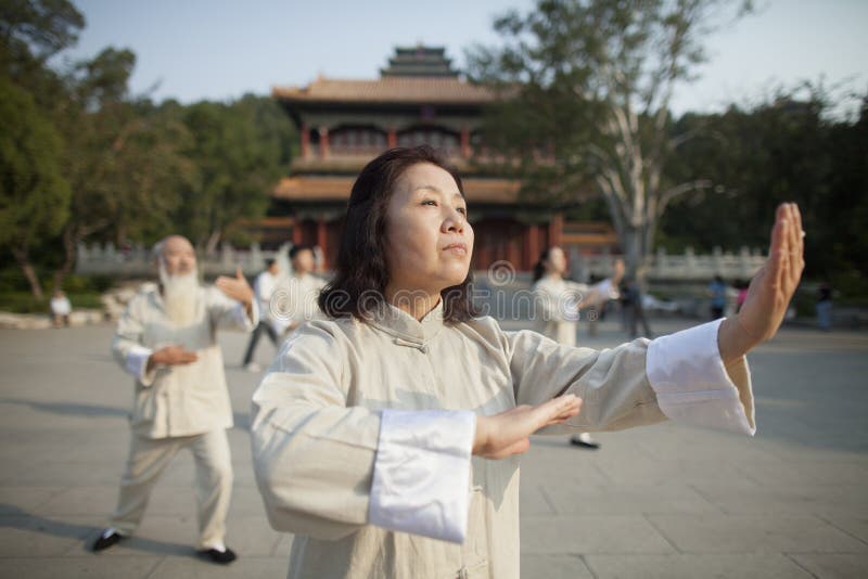 Chinese People Practicing Tai Ji in Front of Traditional Chinese ...