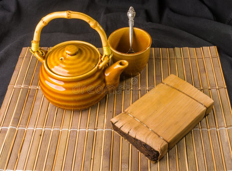 Chinese Pressed PU-erh Tea in Bamboo Leaf Packaging and Tea Accessories ...
