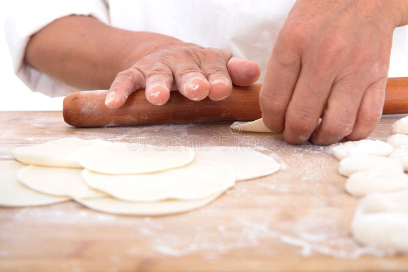 The Chinese Rolls Out Dumpling Skins on a Cutting Board To Prepare ...