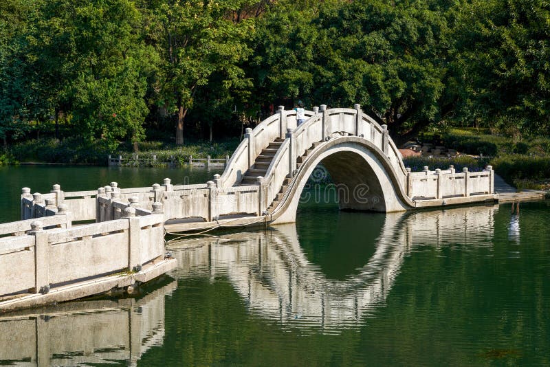 Chinese Traditional Stone Bridge Over Lake in Park Stock Photo - Image ...