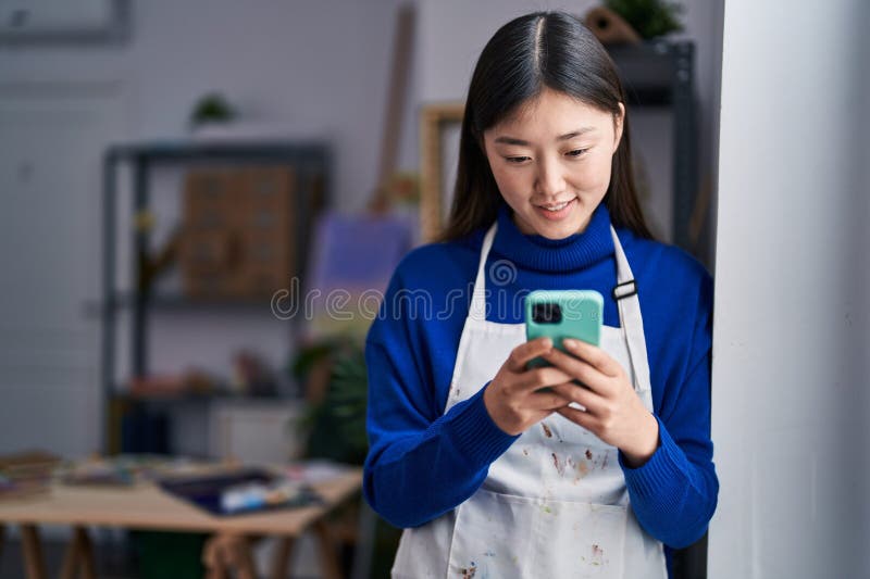 Chinese Woman Artist Smiling Confident Using Smartphone at Art Studio ...