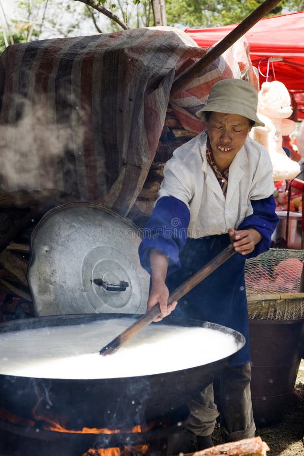 Chinese Woman Cooking Rice editorial stock image. Image of chefs - 25411219