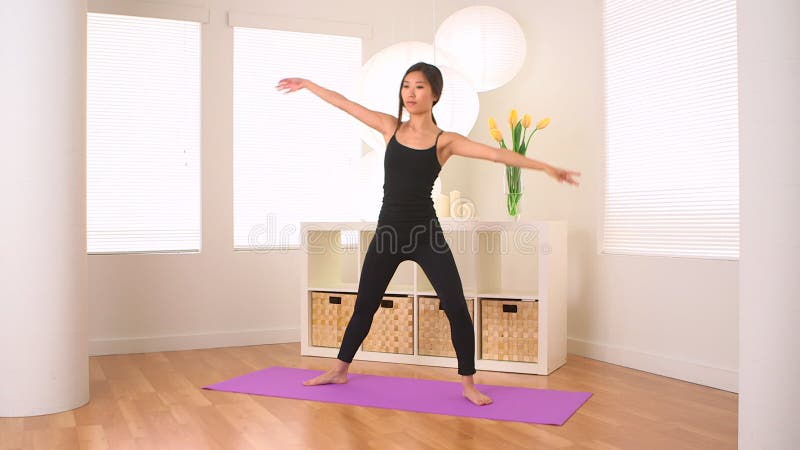 Cute Chinese Woman Doing Yoga Pose Extended Side Angle Stock Video