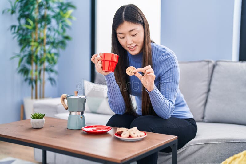 Chinese Woman Having Breakfast Sitting on Sofa at Home Stock Image ...