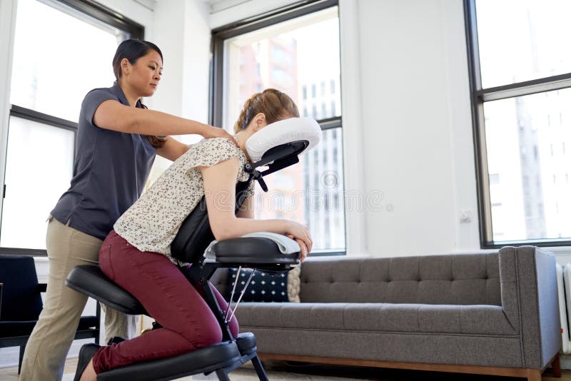 Chinese Woman Massage Therapist Giving A Treatment To An Attract Stock